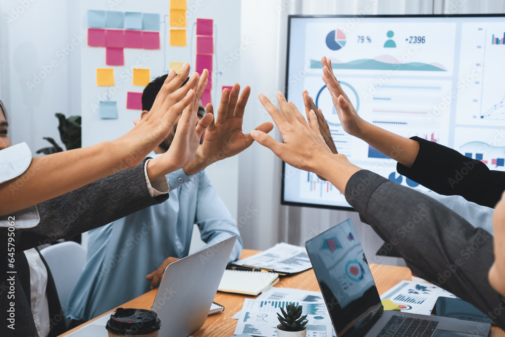 Diverse business team celebrate successful meeting with high-fives and ...