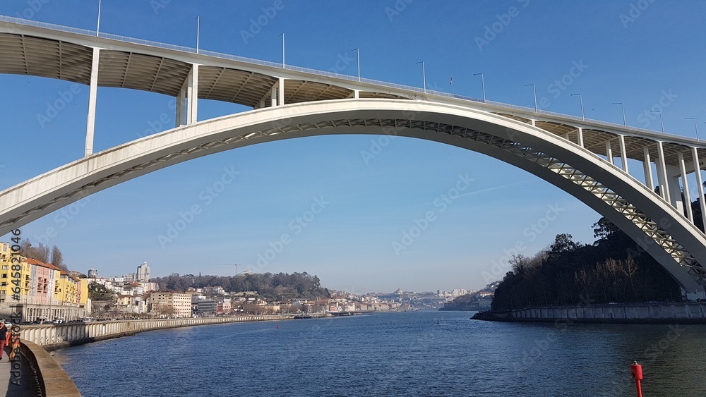 A majestic suspension bridge towers over a sparkling blue bay ...