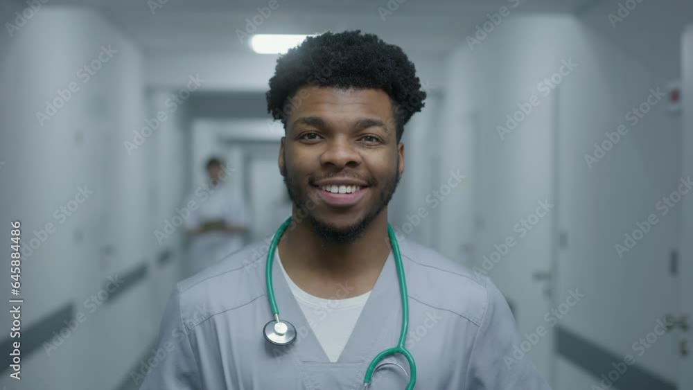 African American doctor stands in middle of medicine center hallway ...