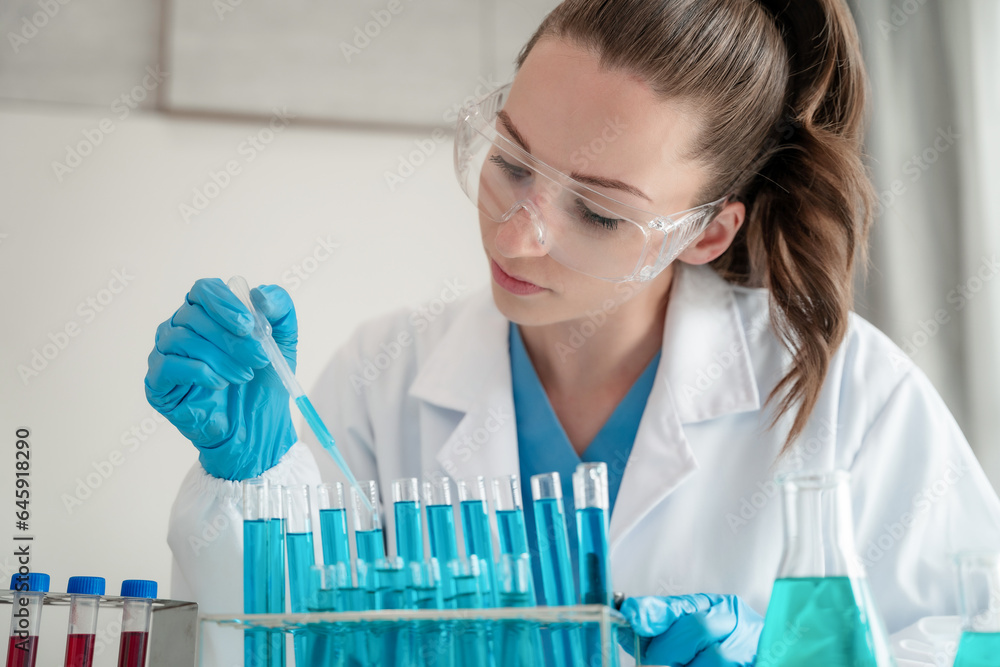 Scientist mixing chemical liquids in the chemistry lab. Researcher ...