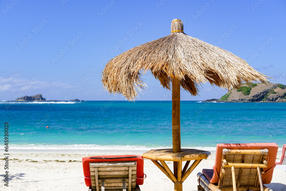 Beachside lounge chairs and umbrellas to relax and enjoy the beauty of ...