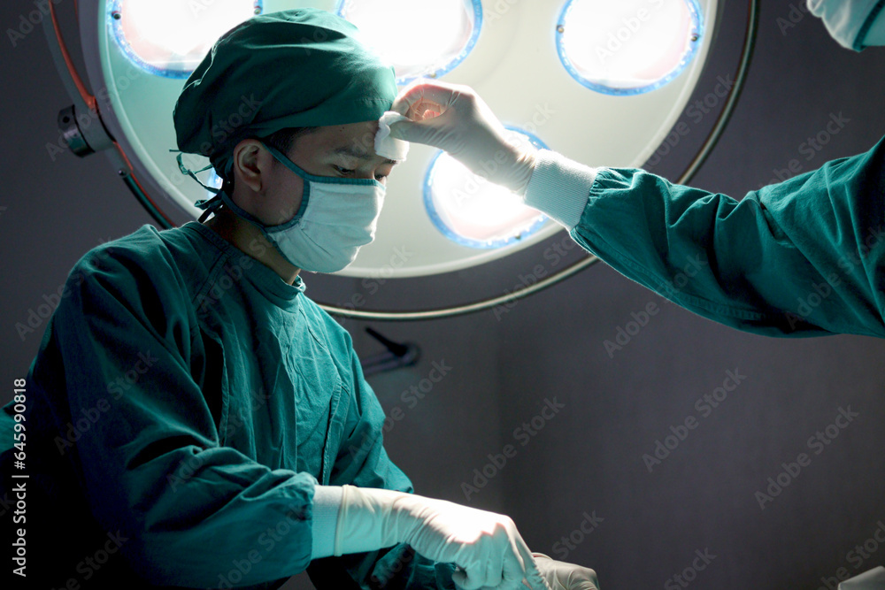 Professional surgical team operating surgery patient, medical staff ...