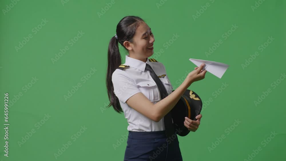 Asian Woman Pilot Is Respectful, Saluting While Standing In The Green ...