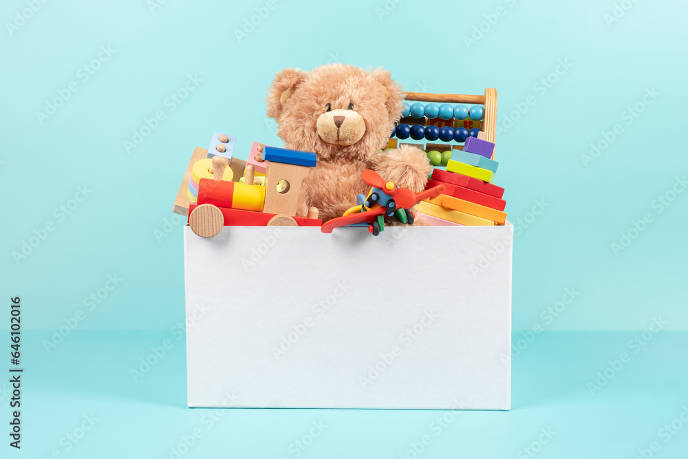 Toy box full of baby kid toys. Container with teddy bear, fluffy and ...