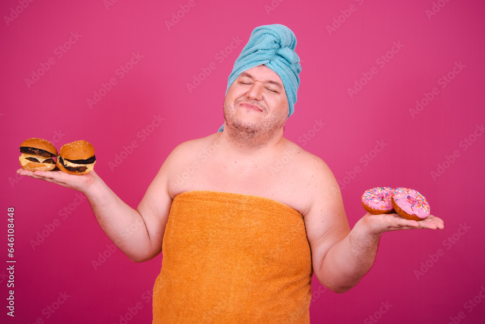 Early morning. Funny fat man gets ready to eat a burger after a shower ...