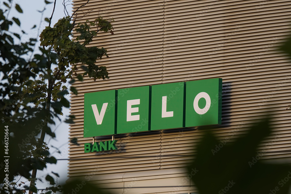 Signboard with name and logo of the bank "Velo" on a facade of a modern ...
