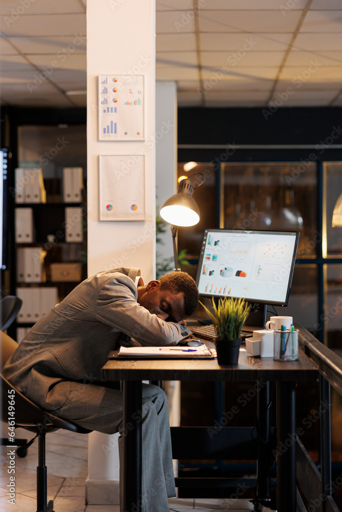 Exhausted manager sleeping on desk table in startup office after ...