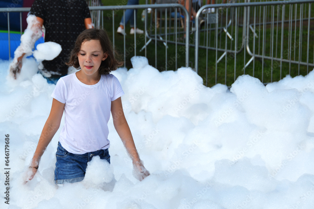 happy girl with foam on her head, in wet clothes at a foam party, in ...
