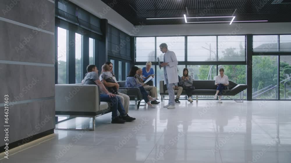 Diverse people sit on sofas in clinic lobby area, wait for doctors ...