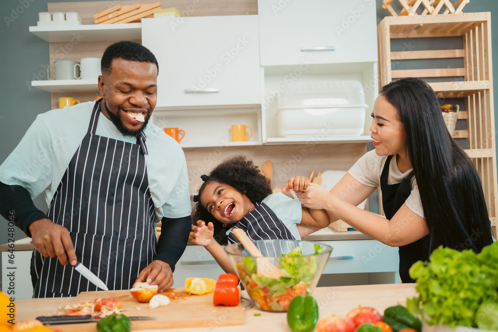 Kind African american parents teaching their adorable daughter how to ...