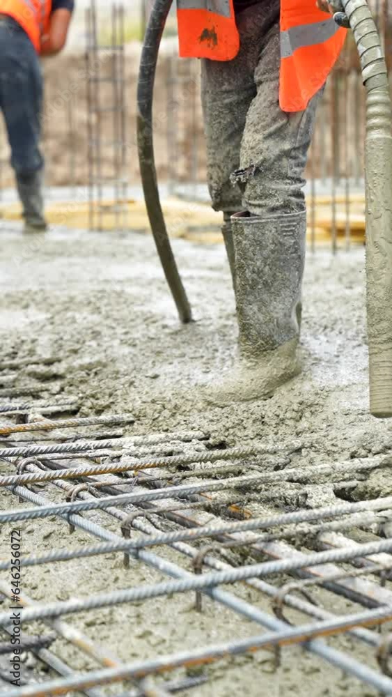 Iron grate or reinforcement on the ground poured with concrete from a ...