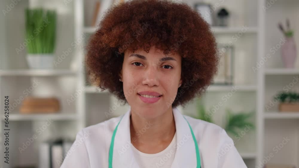 First person view of friendly african american doctor with curly ...