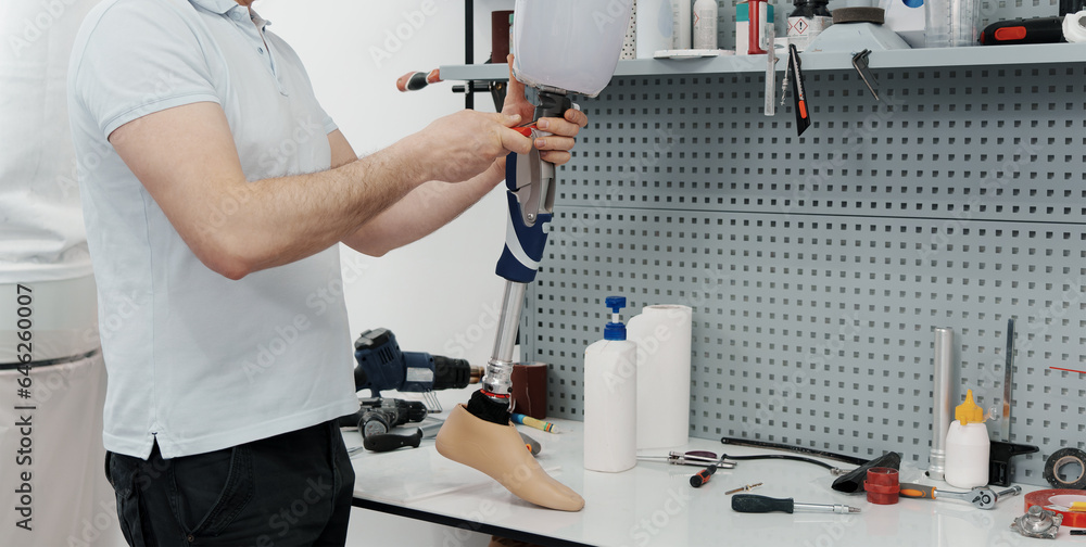 Crop unrecognizable craftsman adjusting and bending modern prosthetic ...