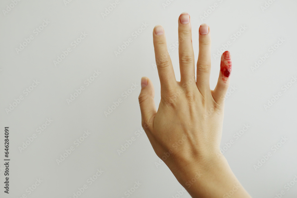 Female hand with red blood, little finger is bleeding profusely. Woman ...