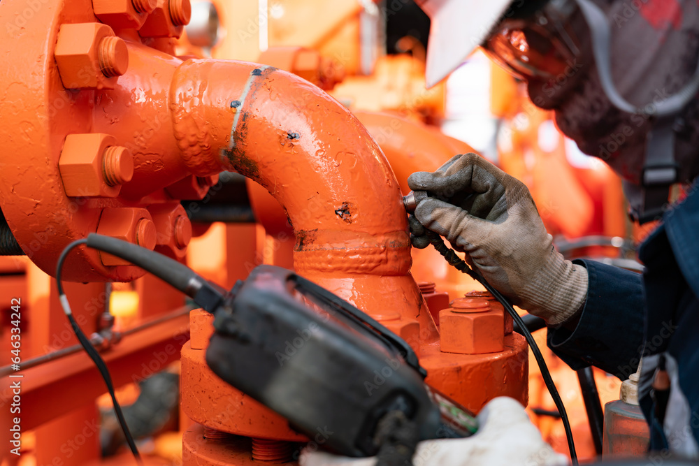 Non-destructive testing technicians are checking the thickness of elbow ...