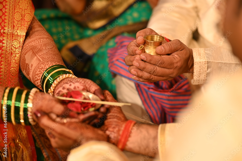 Hindu Bride and Groom with petals of flowers in hands. Kanyadaan ...