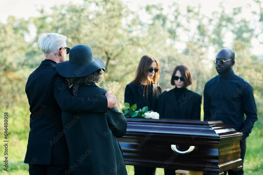 Focus on mature mourning couple wearing black attire standing in front ...