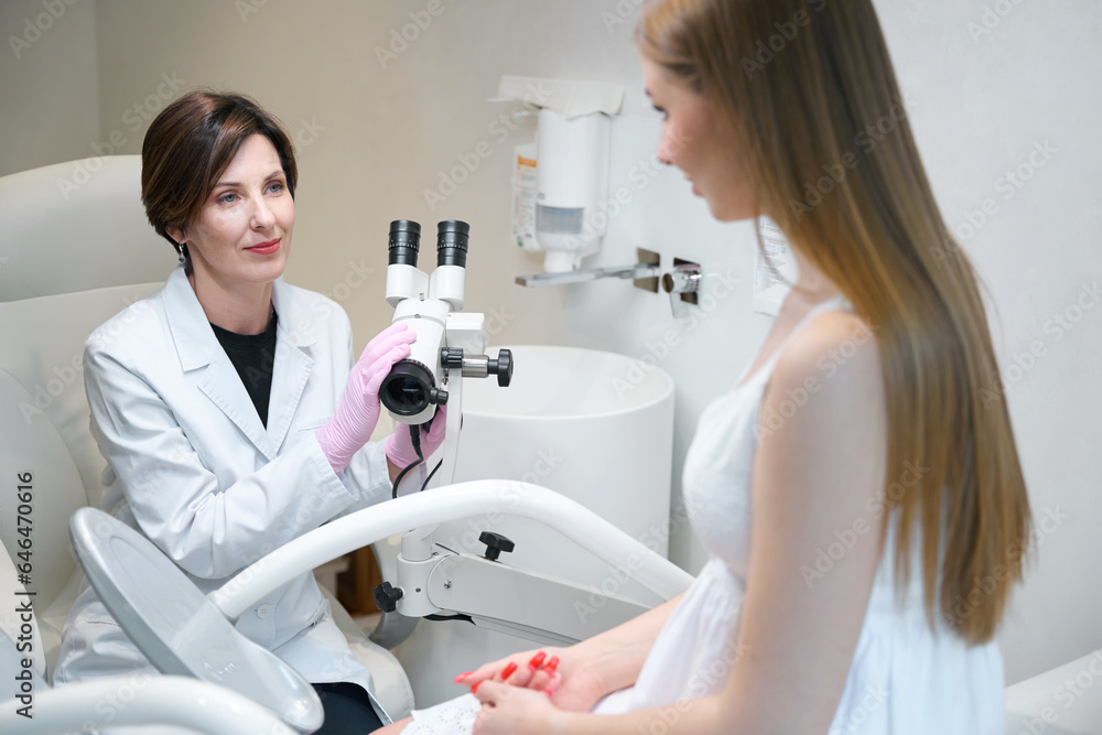 Female gynecologist uses a gynecological microscope in her work Stock ...