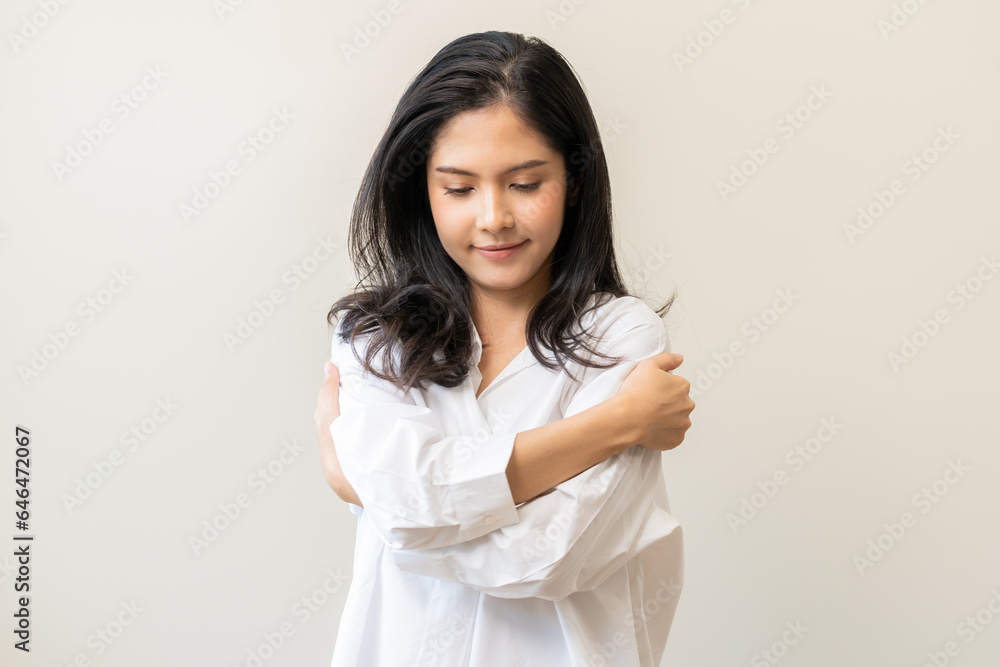 Smiling positive, hugging oneself happy asian young woman hands hug ...