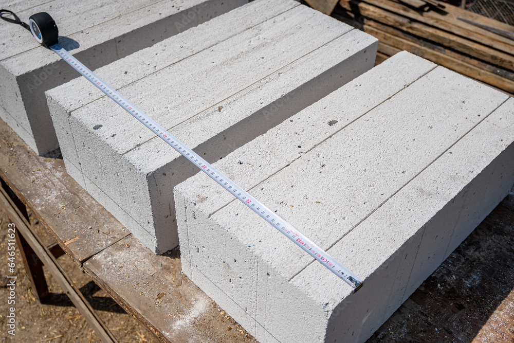 White aerated concrete blocks close-up. Measuring the size of a gas ...