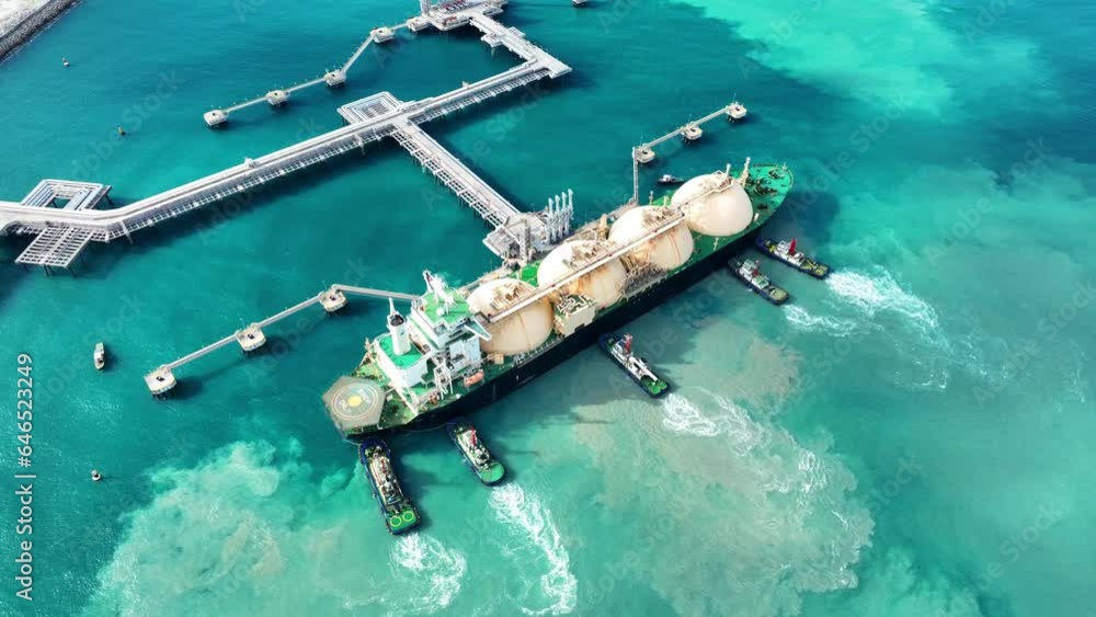 LNG (Liquified Natural Gas) tanker anchored in Gas terminal gas tanks ...