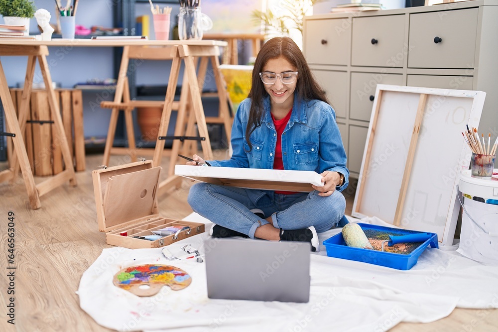 Young hispanic girl artist having video call drawing at art studio ...