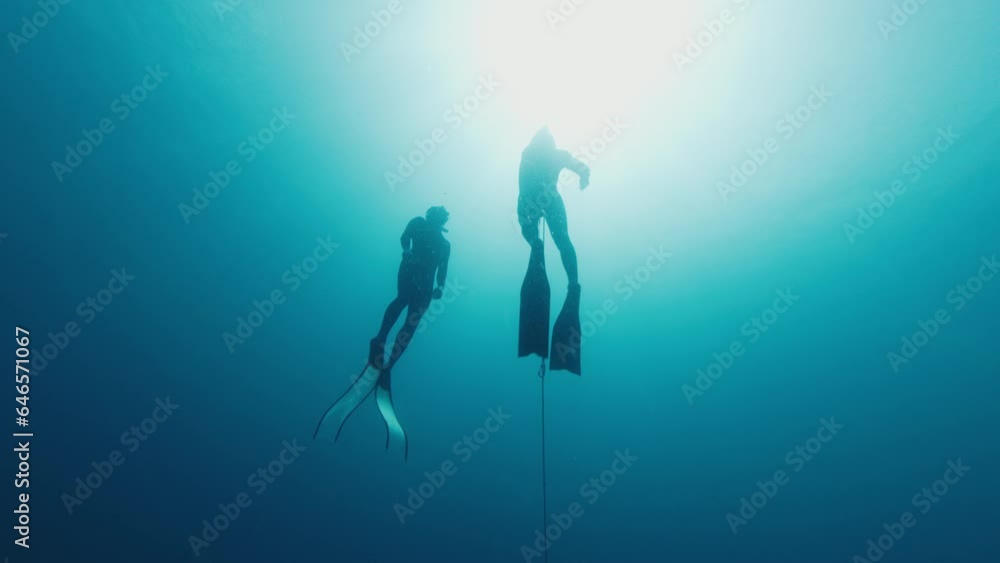 Male freediver ascending along the rope during free diving work out in ...