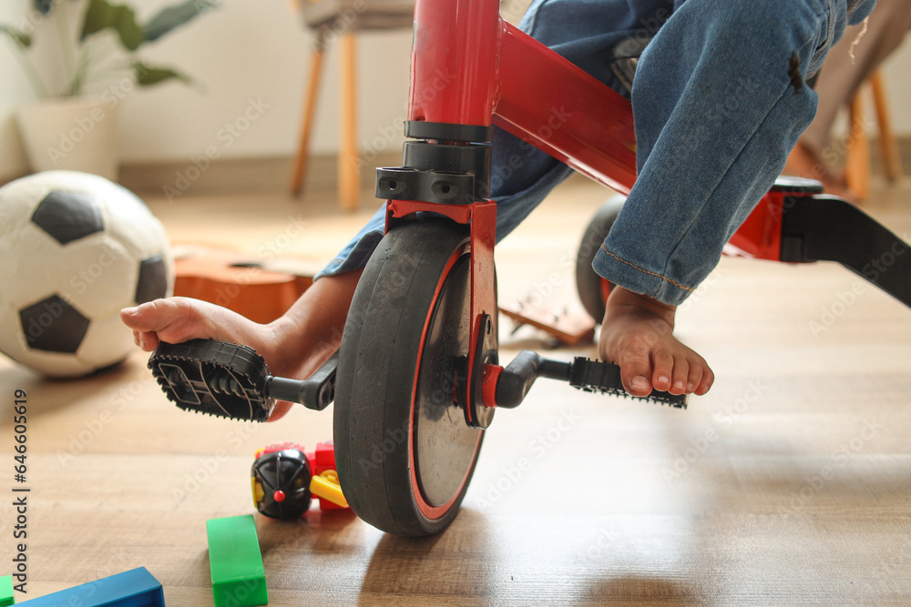 Cute little kid's foot cycling the tricycle pedal. Toodler using bike ...