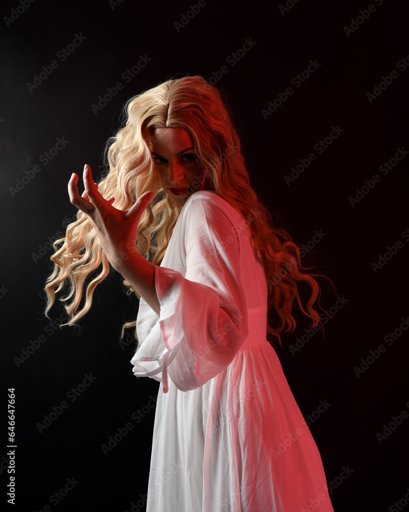 Close up portrait of scary blonde vampire bride wearing elegant white ...