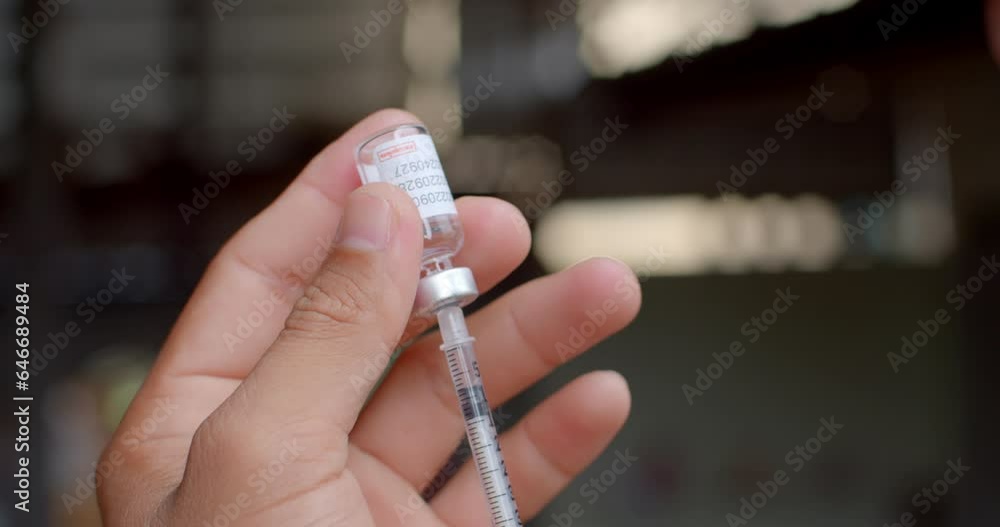 After sucking the medicine out of the bottle, pull out the syringe to ...
