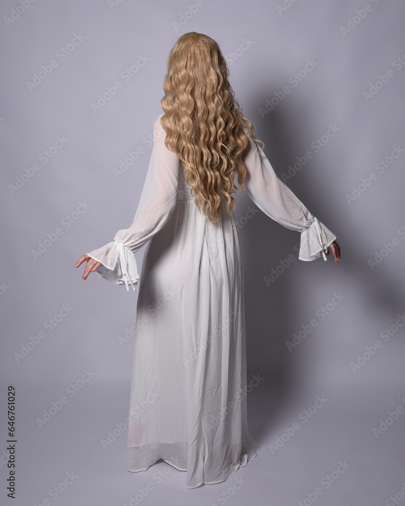 Full length portrait of blonde woman wearing white historical bridal ...