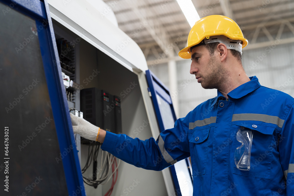 Male electrician engineer maintenance electric system in industry ...