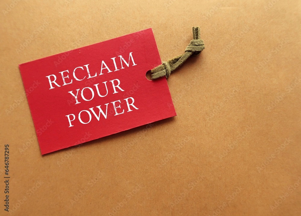 Red tag on copy space envelope with message Reclaim Your Power, self ...