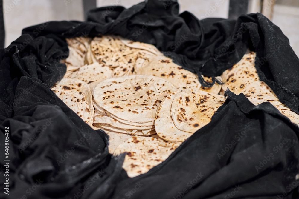 Batch of chapati round flatbreads in black bag for langar in sikh ...
