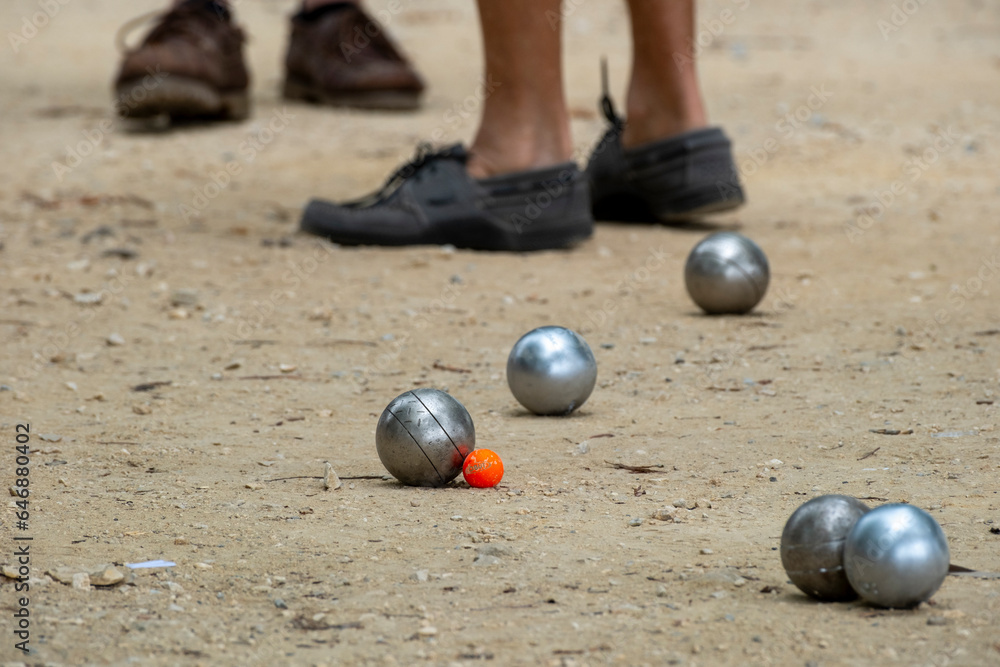 Petanque ball boules bowls on a dust floor, photo in impact. Game of ...