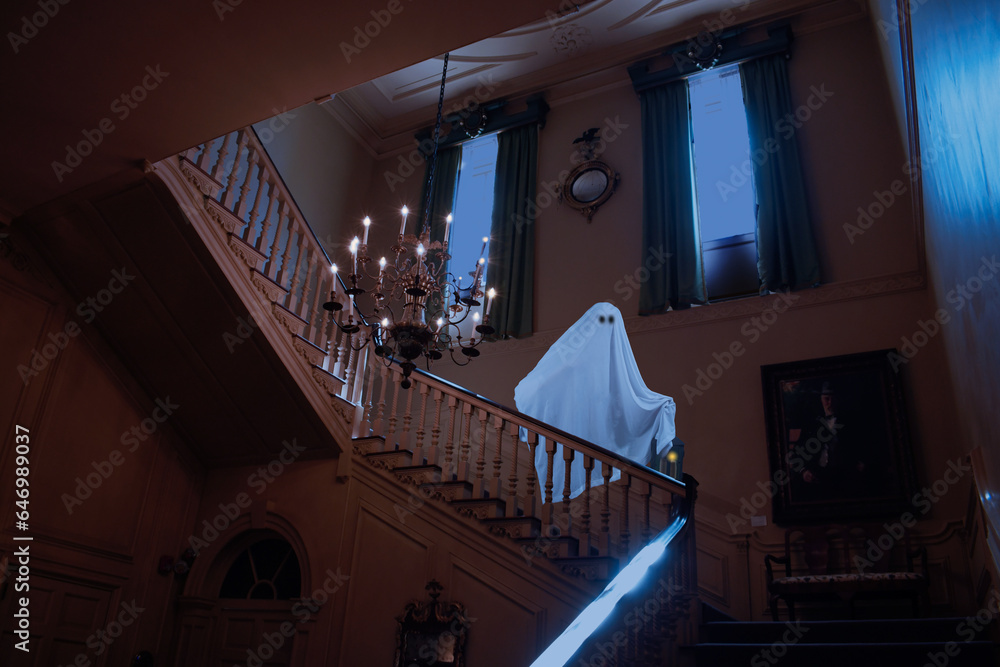 Ghost going down the stairs in a hunted mansion in the evening, with a ...