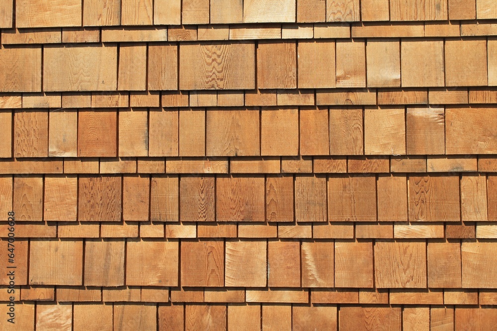 Exterior wall covered in wooden cedar shakes in repeating grid pattern ...