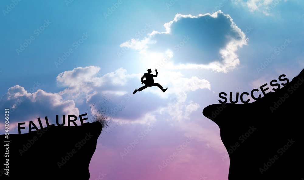 Silhouette of businessman leaping or jumping across two cliffs ...