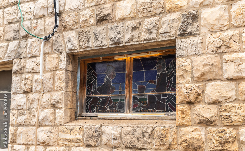 Colored stained glass window in stone wall window made by a local ...