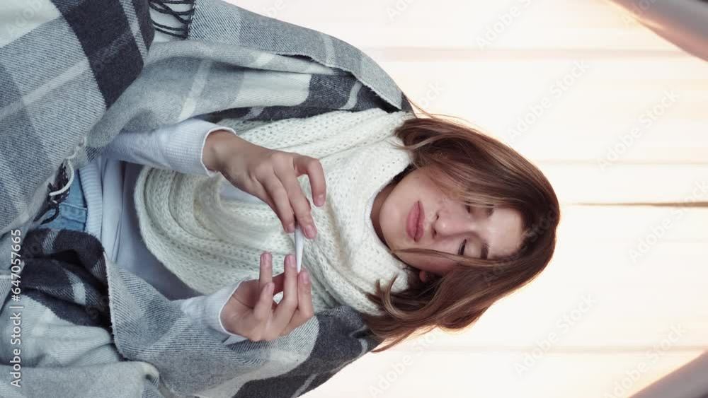 Vertical video. Sick fever. High temperature. Unhealthy woman wrapped ...