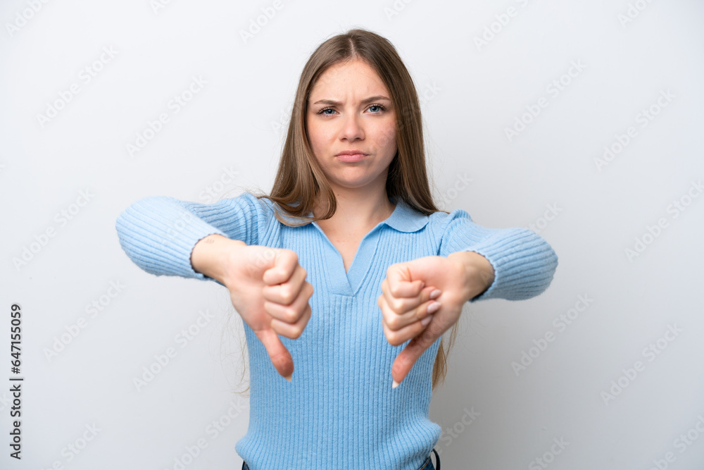 Young Lithuanian woman isolated on white background showing thumb down ...