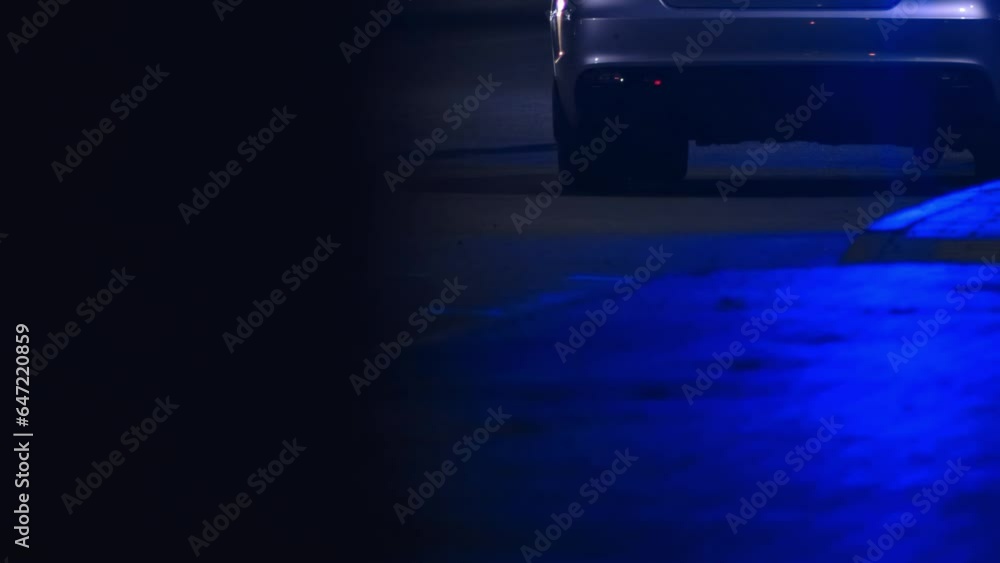 Legs of pedestrians cross road at night. Feet of highway patrol ...