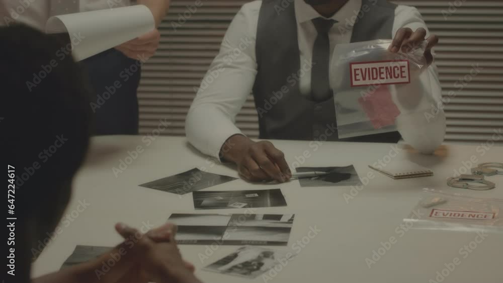 Over the shoulder shot of African American male police officer showing ...