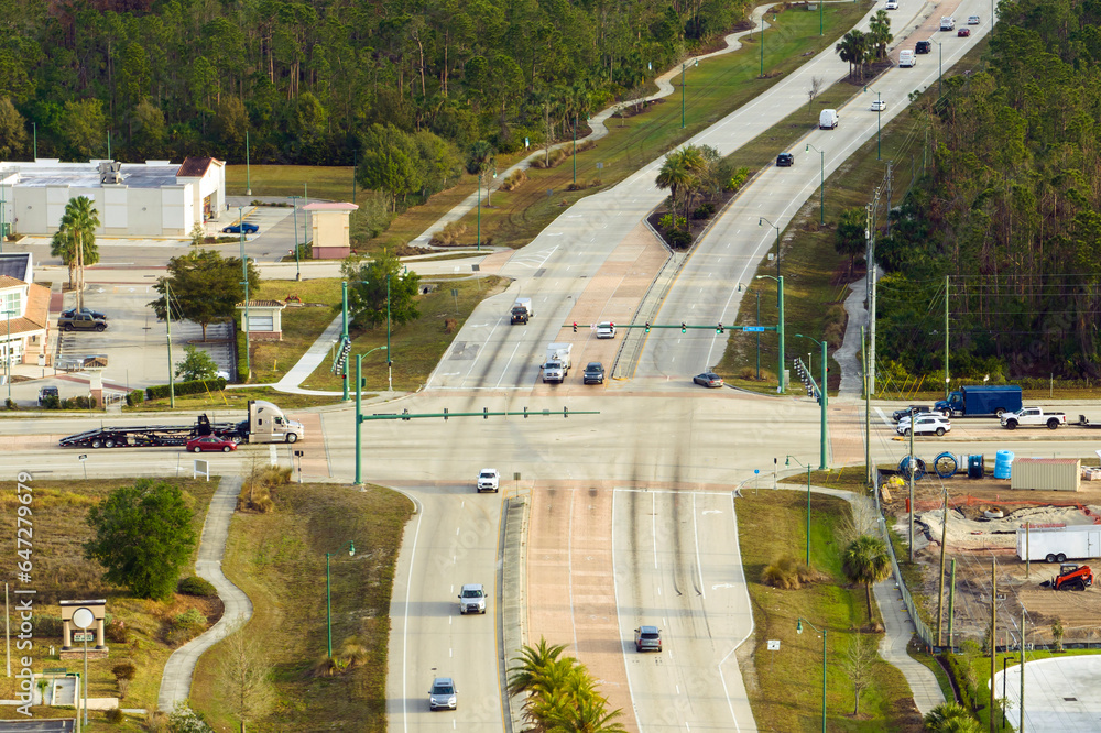 Top view of wide road with moving cars at intersection with traffic ...