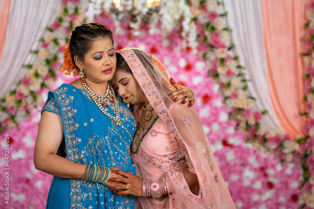 Sad Mother crying by hugging bride daughter during marriage ceremony on ...