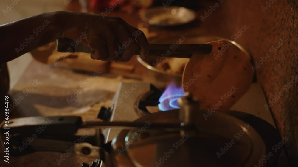 Cook sculpts and rolls wheat dough and cooks a traditional Indian dish ...