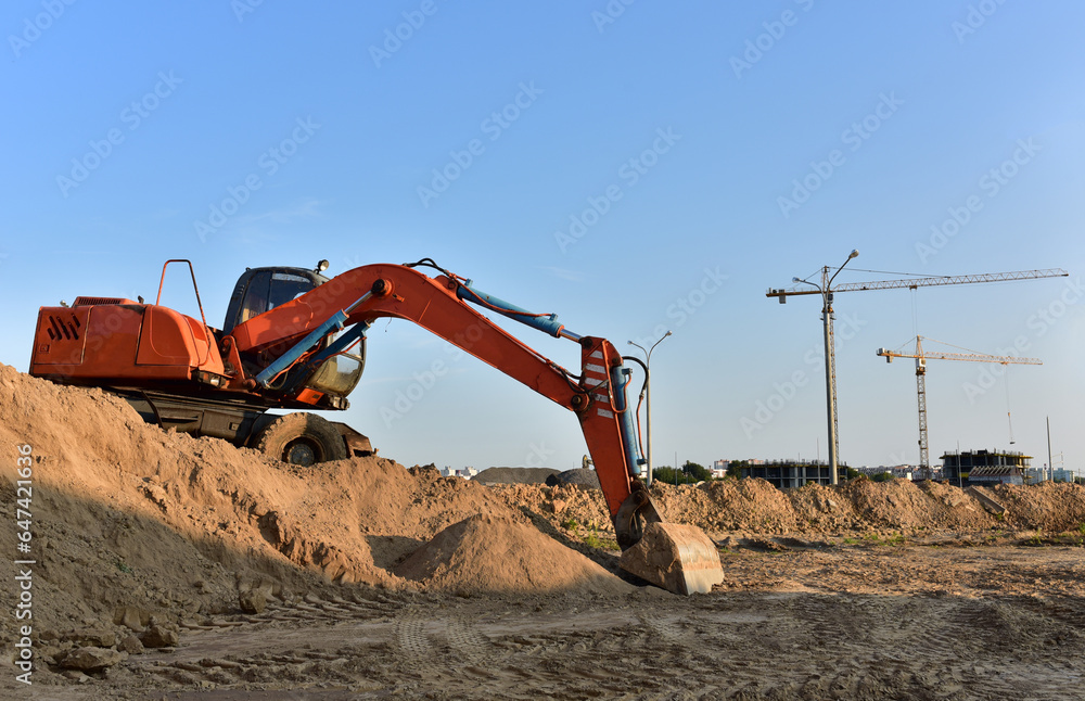 Excavator dig ground at construction site. Dig foundation. Tower crane ...