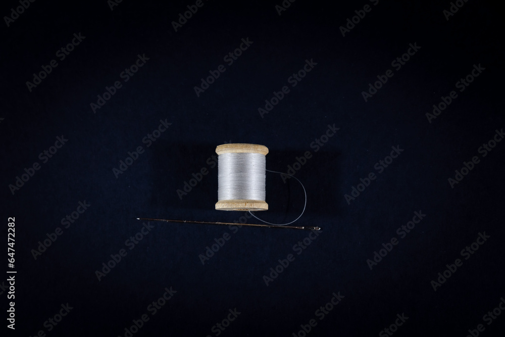 Selective blur on a Studio shot of a white thread reel and a sewing ...