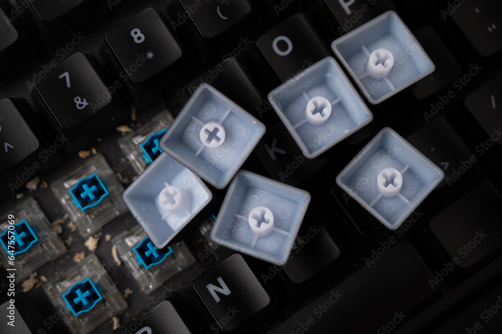 Close-up of a dirty mechanical keyboard with blue switches, with some ...