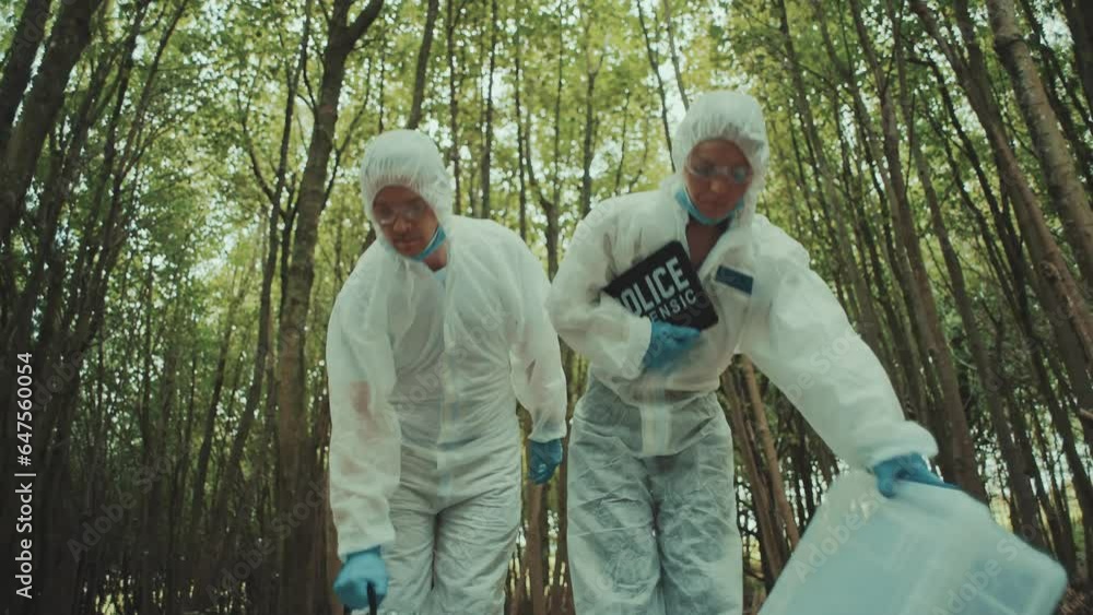 Forensic police investigators arriving at a crime scene and assessing ...